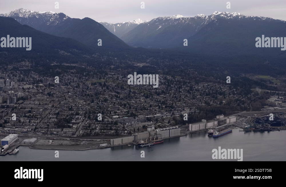 Aerial View Of North Shore In Vancouver Harbour With Snowy Mountains In ...