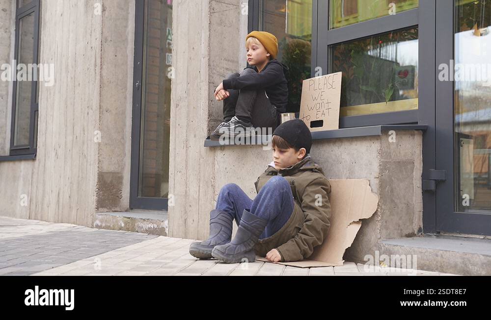 Two poor street boys need help asking help food donation from strangers ...