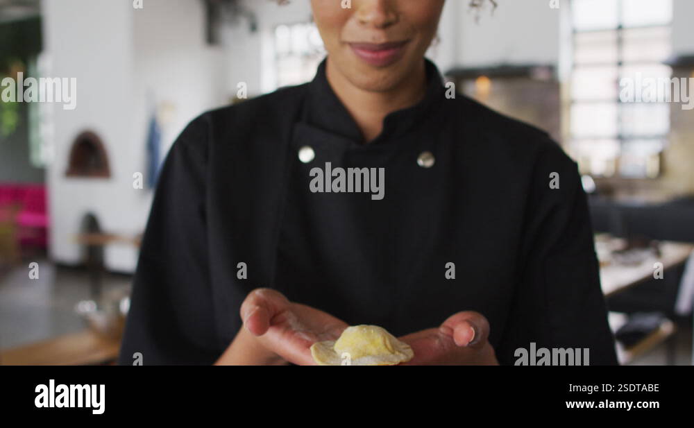Mixed race female chef showing a patty to camera Stock Video Footage ...