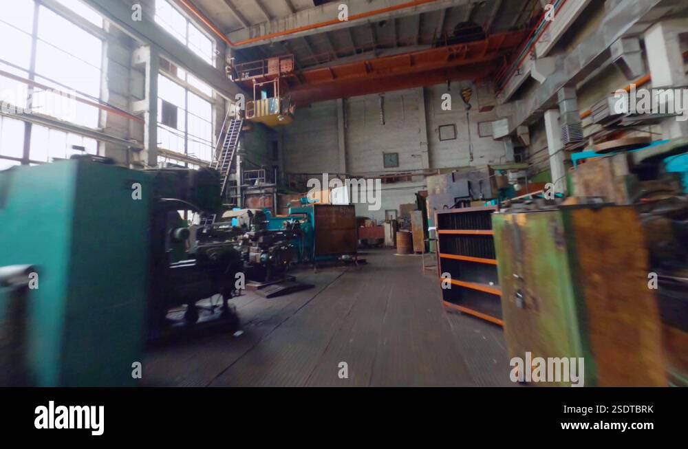 Aerial, FPV, drone shot flying low, between and over machinery inside ...