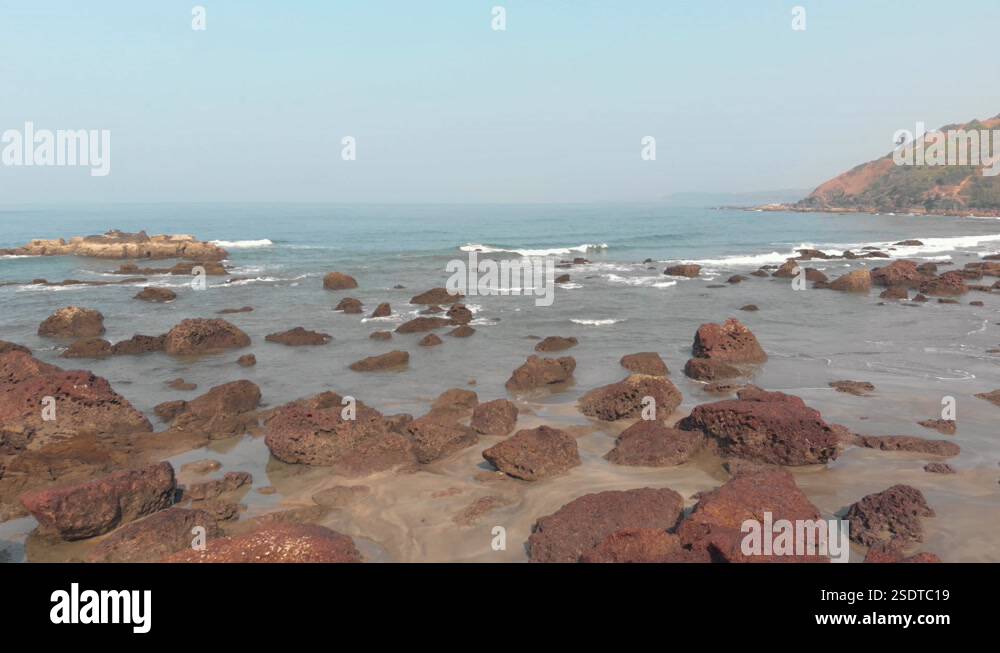 Fly over small beach rocks, serene and quiet Arambol beach, Goa, India ...