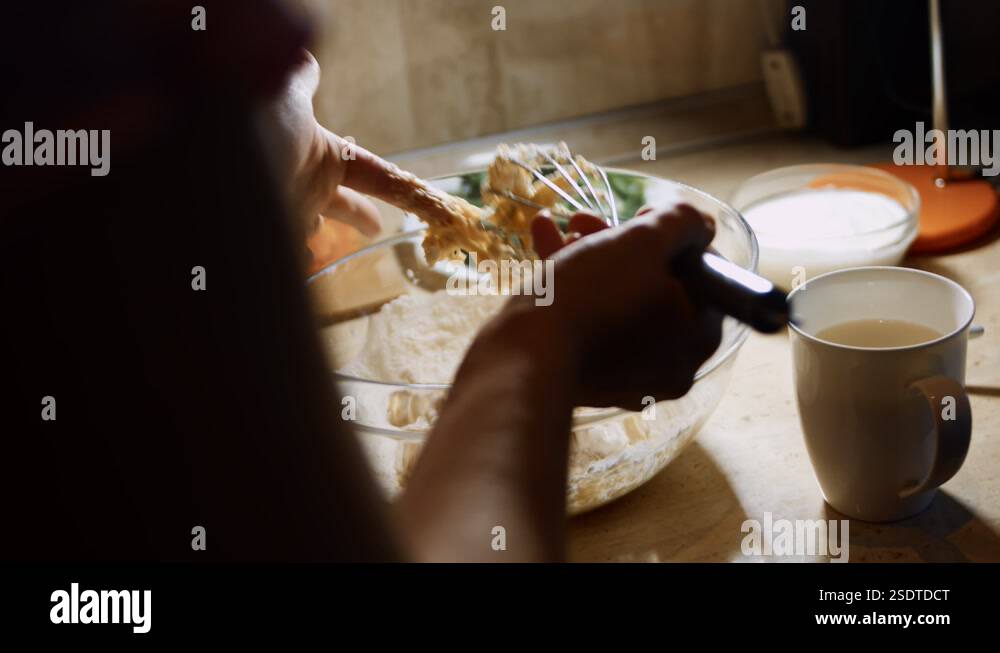 Mixing fresh eggs and flour and cleaning the steel hand mixer. Process of Stock Video Footage ...