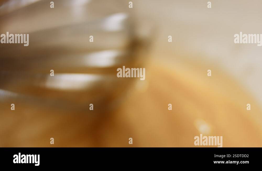 Mixing fresh eggs with steel hand mixer in a glass bowl. Process of preparing Stock Video ...