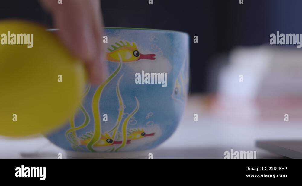 Lemon lies in front of a hot cup of tea and the focus changes. 4k ...