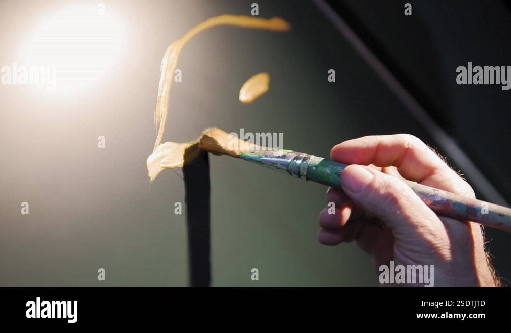 Slow motion: Low angle of man that drawing and painting with a brush ...