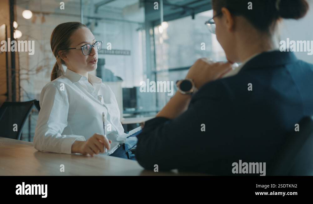 Job interview with young woman in office. Interviewer interviews job ...