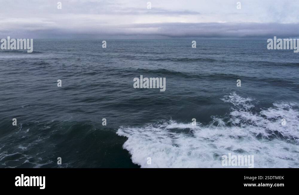 DJI FLY Aerial view winter coastal ocean line. Waves crashing on the ...
