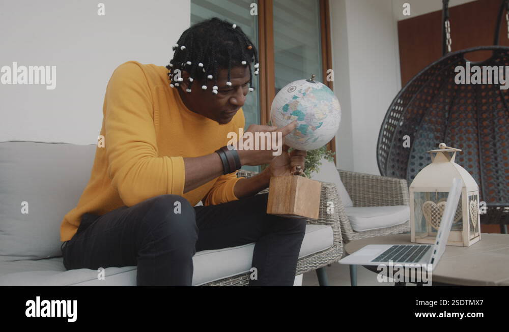 African american black man spinning the globe. Picking random location ...