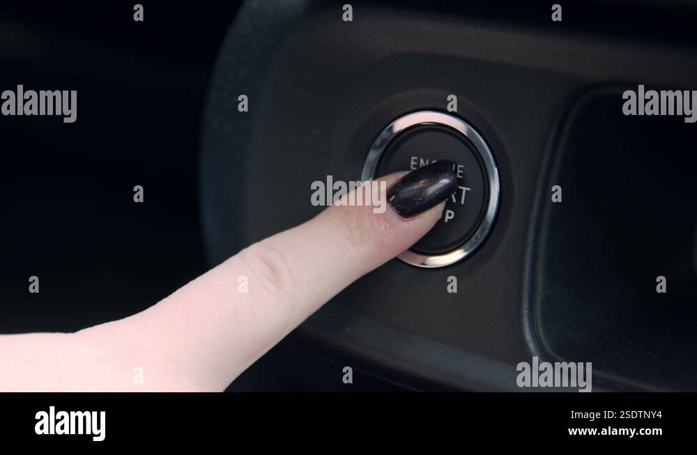 The girl starts the car with the start-stop system. 4K, Slow motion ...