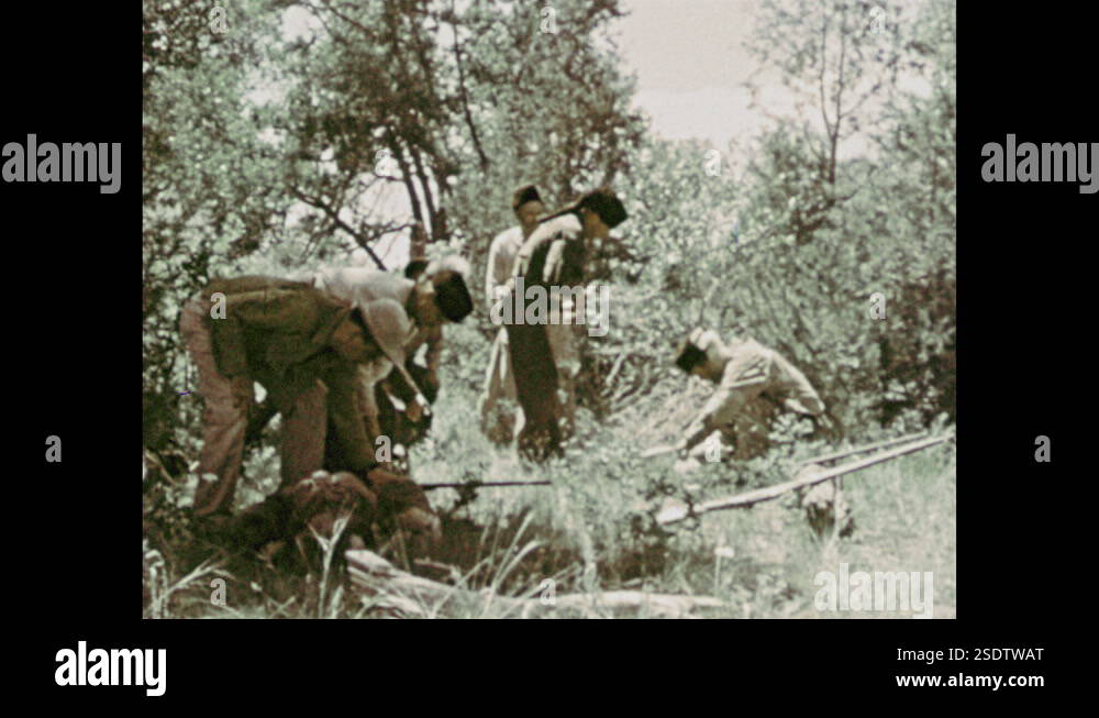 1960s: group of frontiersmen in woody clearing, some in coonskin caps ...