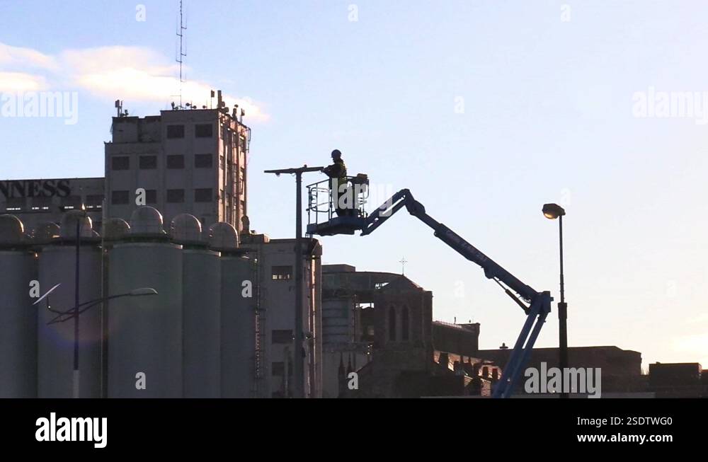 Zooming or dolly shot on a factory workman working in high visibility ...