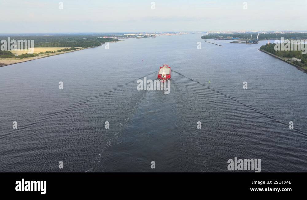 Zooming out of an aerial view of an empty cargo ship moving from an ...