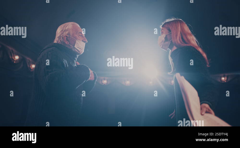 Actors in masks quarreling on stage in spotlight Stock Video Footage ...