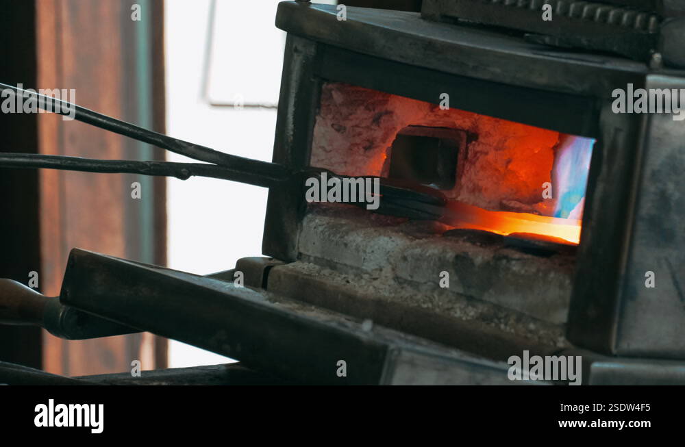 Professional Blacksmith Shapes Knife On Anvil, Using Hammer. Slow ...