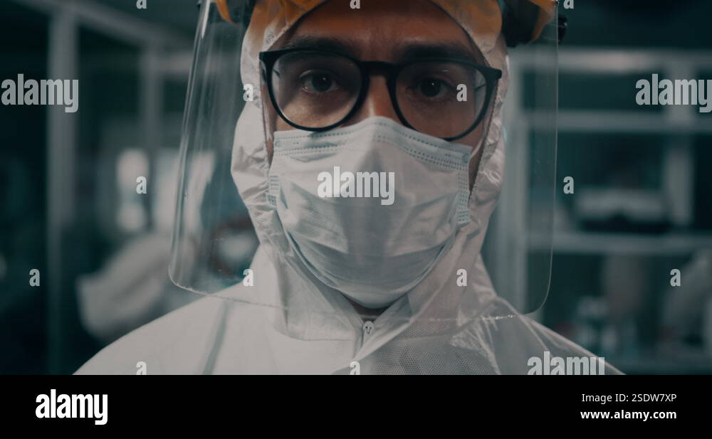 Doctor putting on face shield in lab Stock Video Footage - Alamy