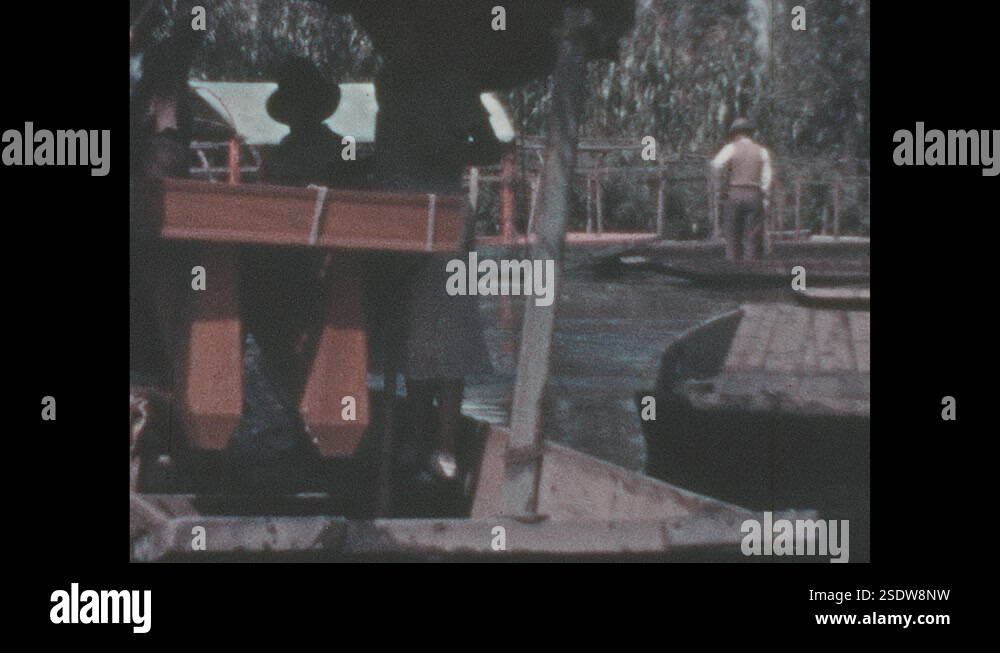 1930s: Large, fancy building on top of hill. Driving through hillside ...