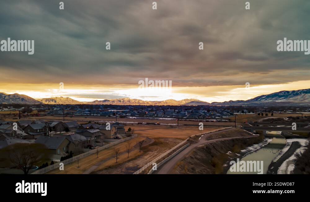 Gloomy cloudscape above the sunshine with an urban area below and the ...