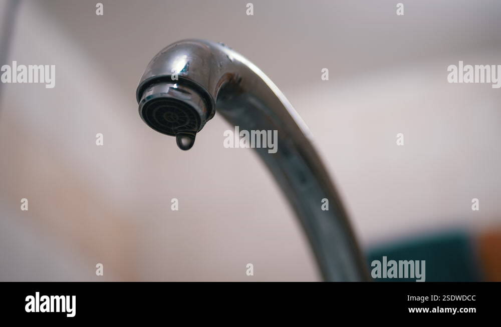 Drops of Water Slowly Flow Down, Fall into Sink from Water Tap. Leak ...