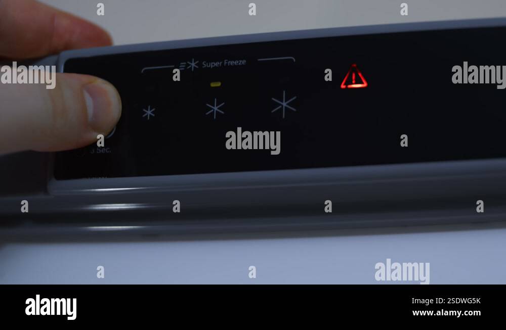 Electronic control on a touch panel of a freezer. Alert indicator ...