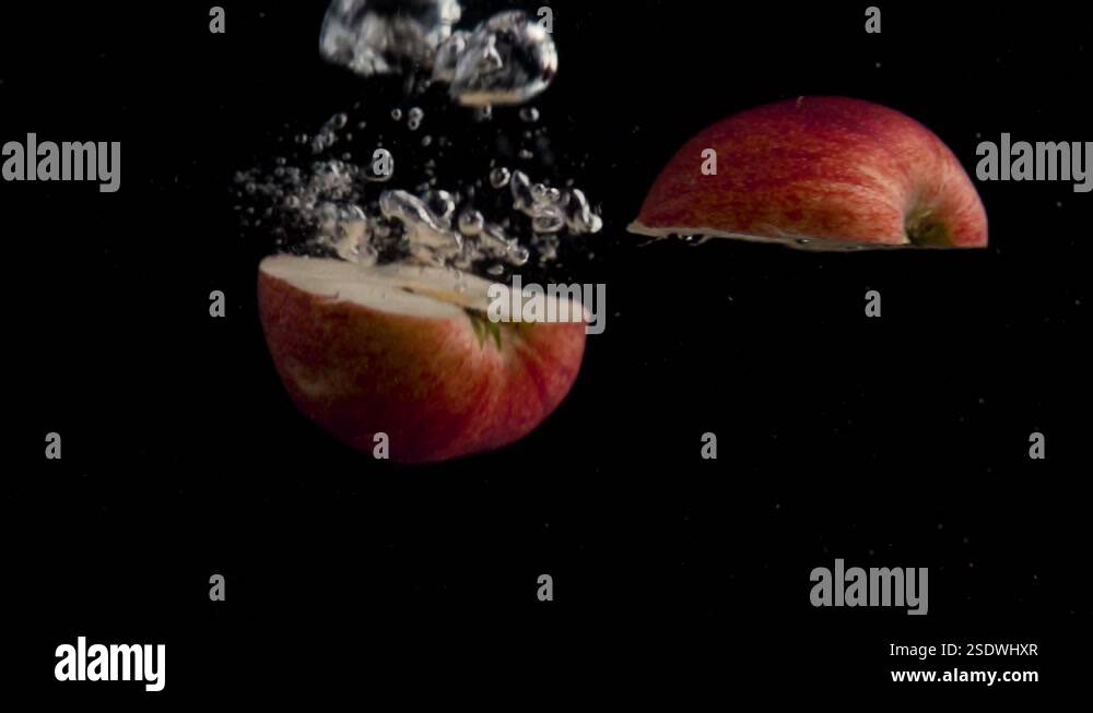 Apple Falling into Water Super Slowmotion, Black Background, lots of ...