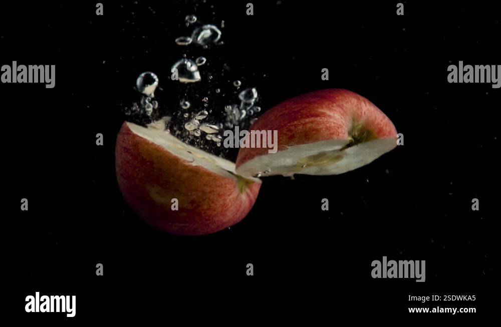 Apple Falling into Water Super Slowmotion, Black Background, lots of ...