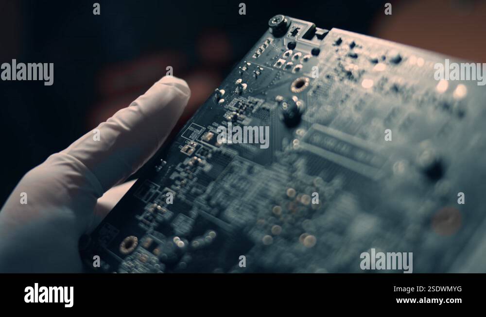 Macro view of engineer's hands holding and closely analizing a GPU ...