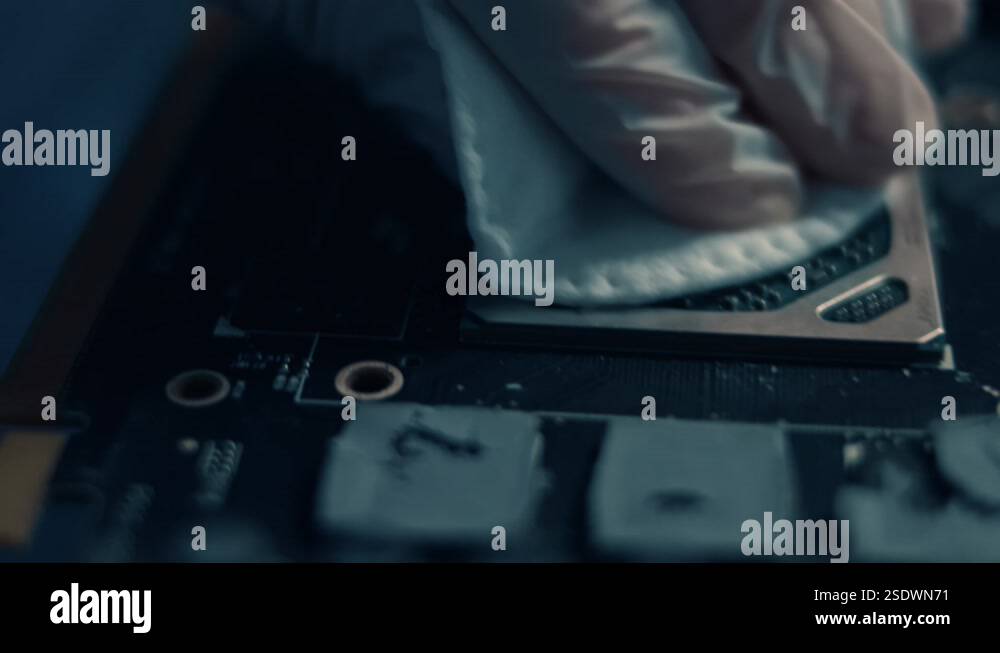GPU Graphic card. Macro view of technician's hand cleaning the dirt of ...