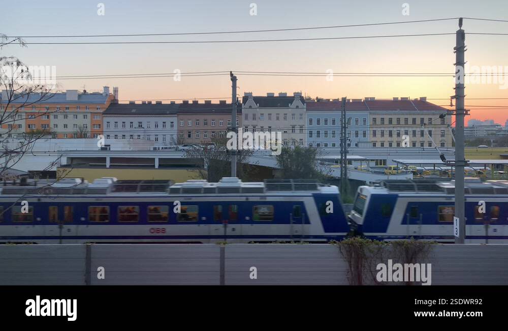 Various scenes of commuter trains passing in front of buildings in the ...