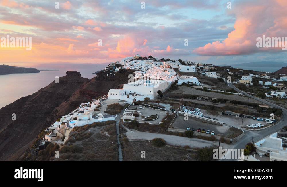 Cinematic aerial shot flying over Thera city in Santorini on a ...
