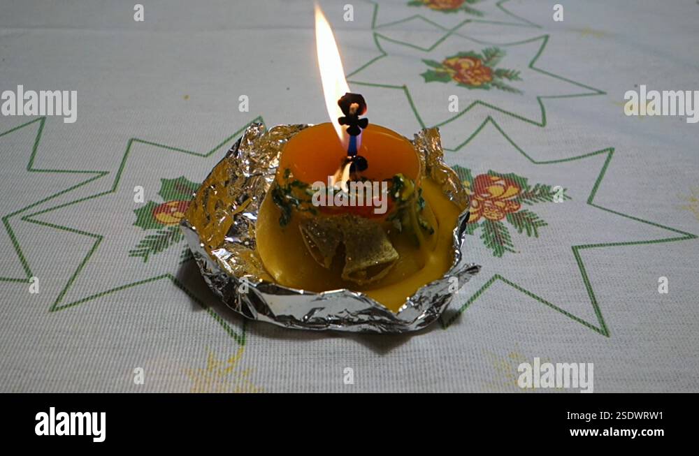 A Christmas candle burns in honor of the birth of Jesus Christ Stock ...