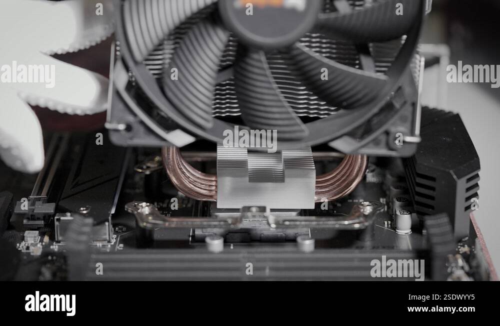 An engineer installs a cooling system in a supercomputer. The central ...