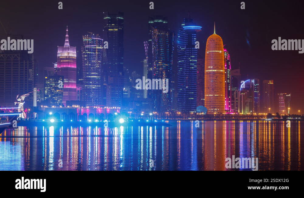 Traditional dhow boat in Doha at night timelapse, with modern buildings ...