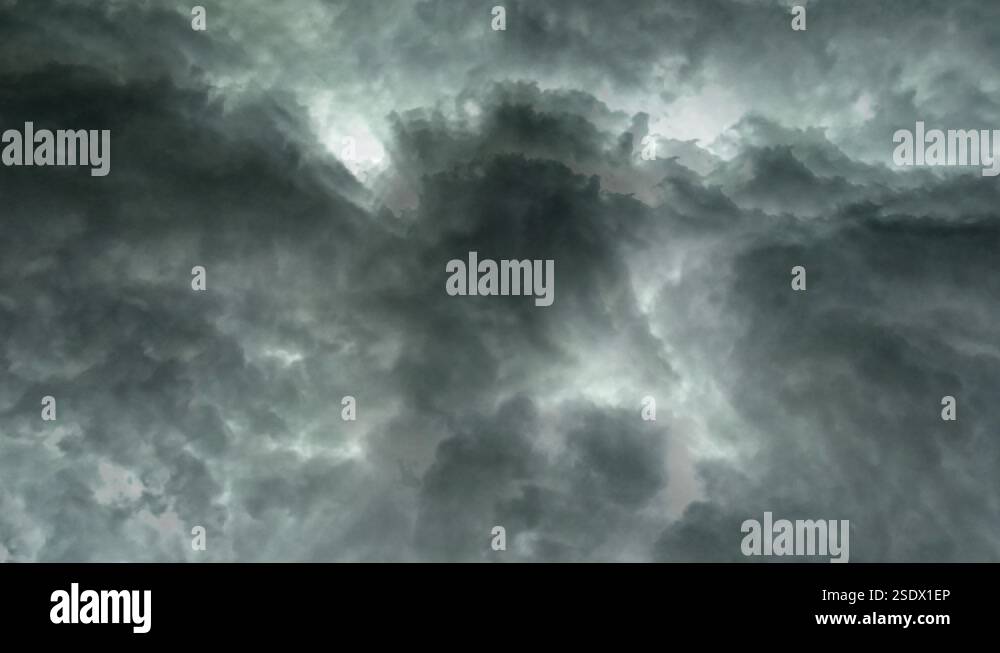 a thunderstorm with lightning that flashed inside the moving dark ...