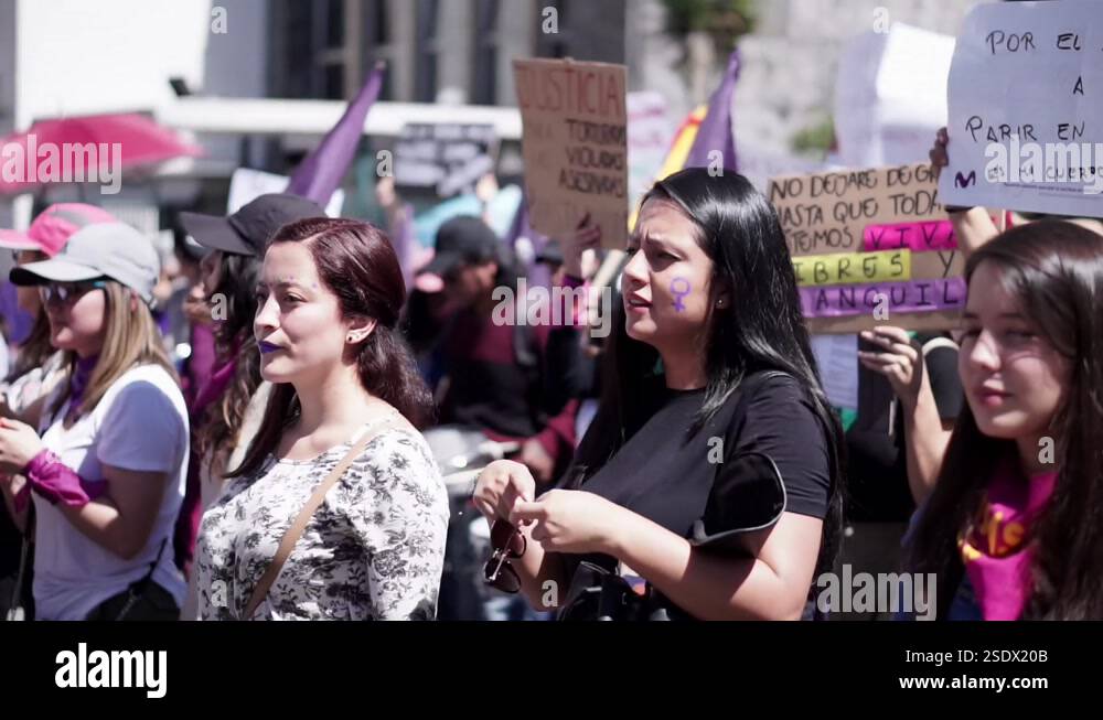 Women are marching and holding signs during the International Women's ...