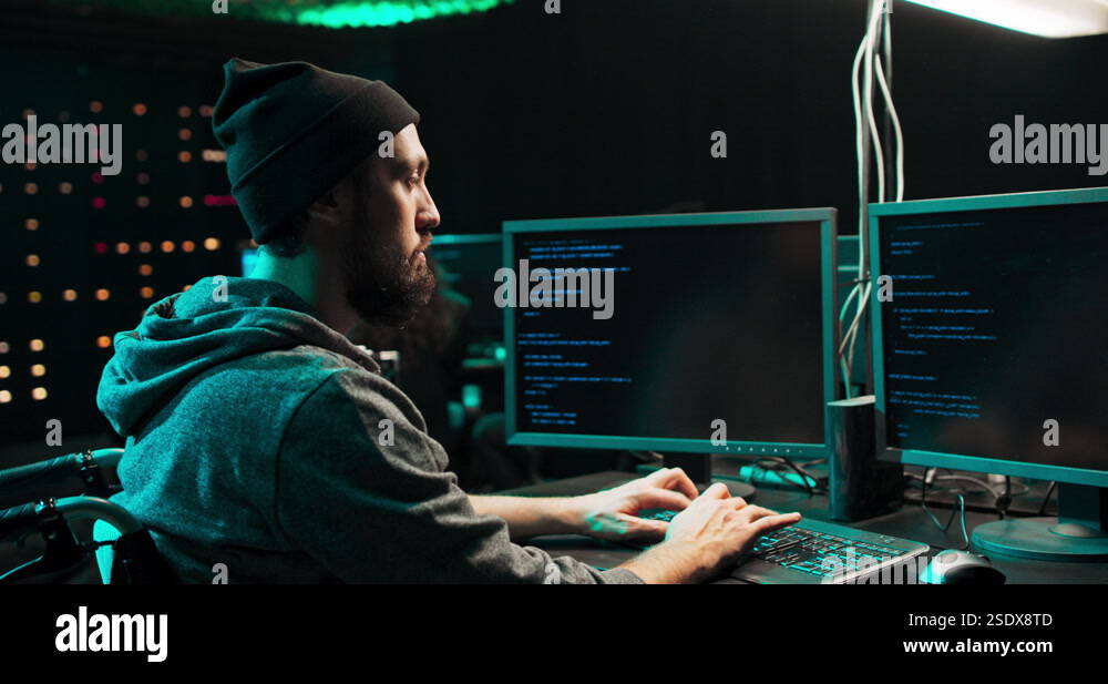 Male Hacker Using Keyboard To Type A Dangerous Malware Into Bank System