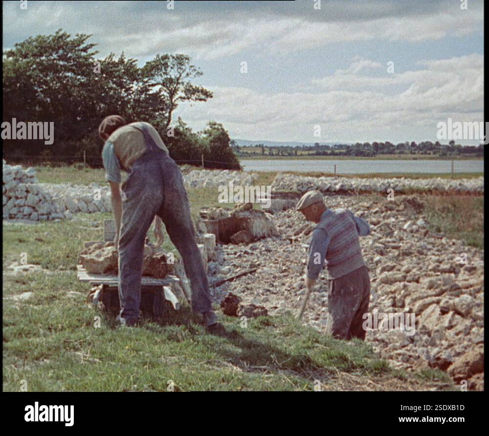 Two men manually quarrying clay and stone near the sea, Northern ...