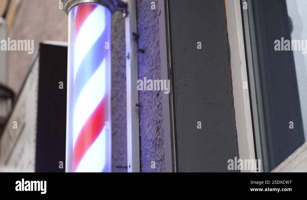 A barber's pole, unusual symbol of barbershops Stock Video Footage - Alamy