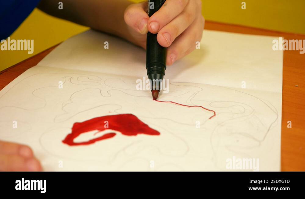 Left hand writing theme. Close-up of a child draws with a marker with ...