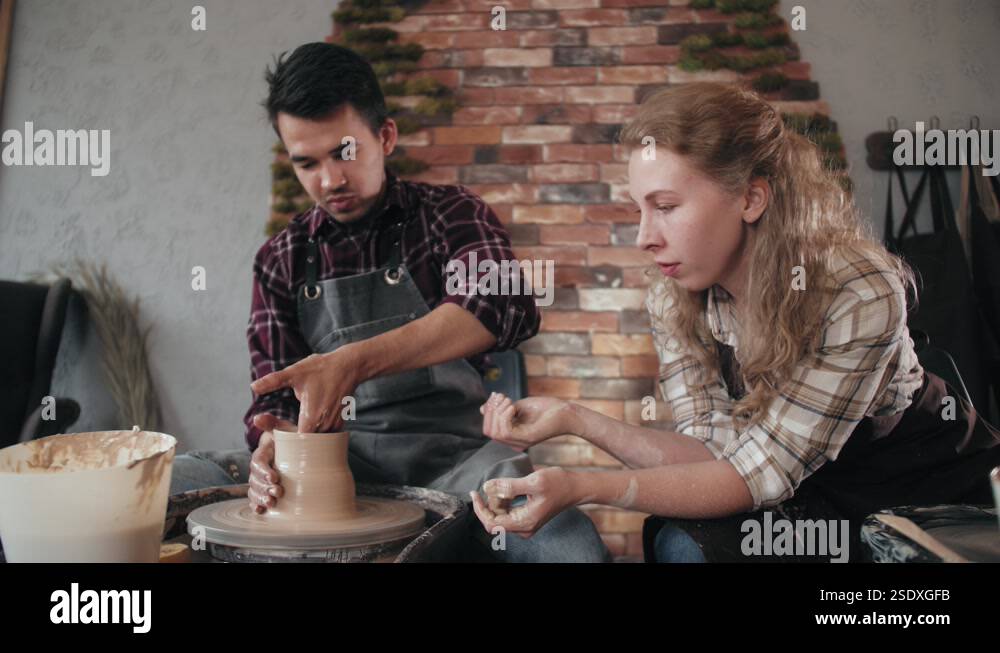 Potter masterclass, Man and woman are working with pottery wheel making ...