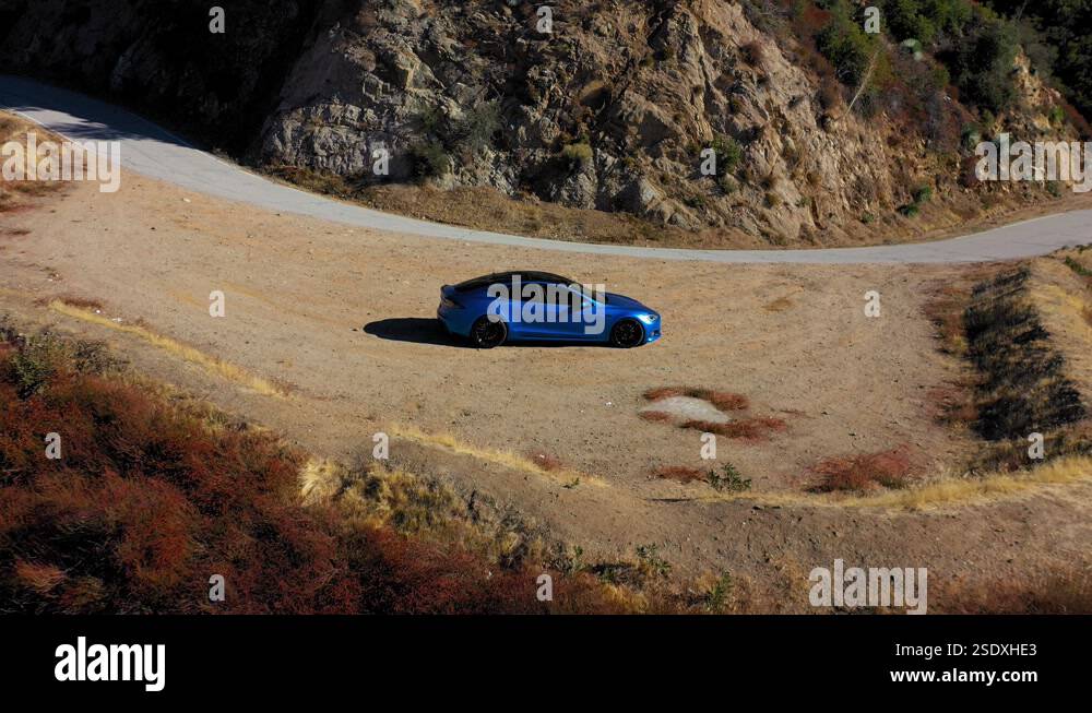 Slowly flying away from a blue Tesla Model S on Mt. Baldy in Southern ...
