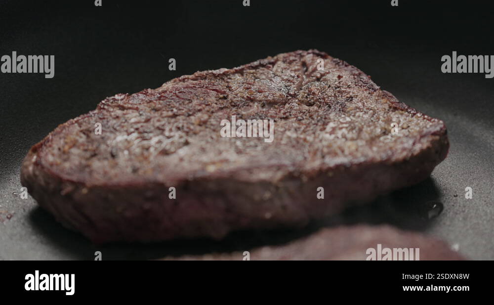 Slow motion two beef steak pieces frying on nonstick pan Stock Video ...