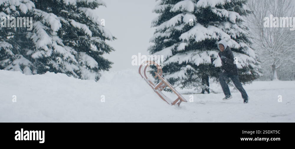 African American Black kid boy having a snowbrawl, jumping and throwing ...