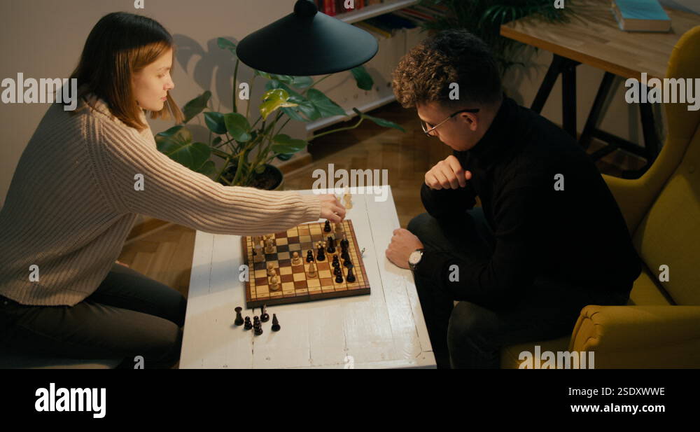 Man and Woman Play Chess Game at Home at night. Sport and Hobby at ...