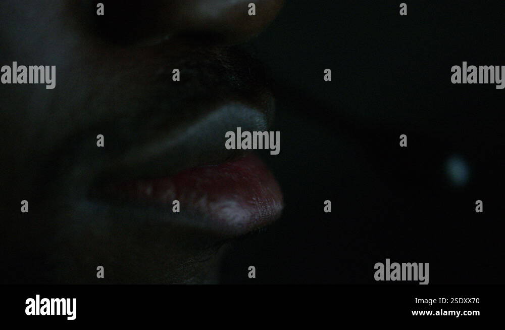 Extreme close up of young mans face as he plays video games and talks ...