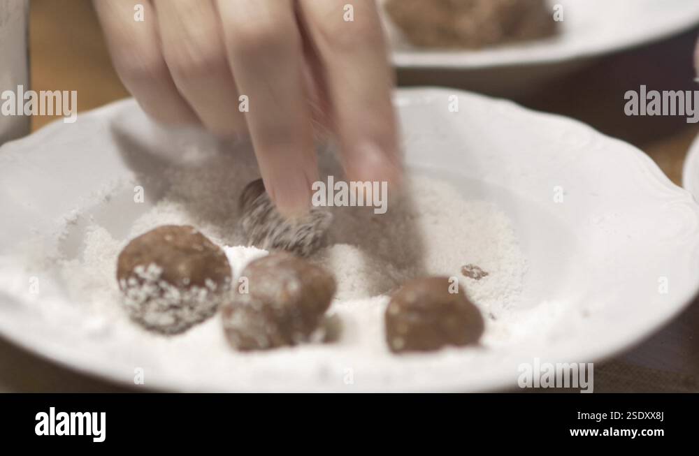 Woman's Hand Rolling The Chocolate Balls Into Desiccated Coconut In ...