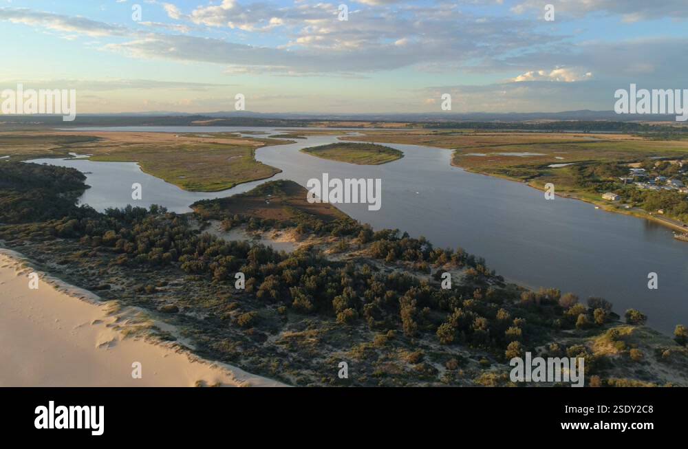 Forward flight over ocean beach descending towards Snowy River at ...
