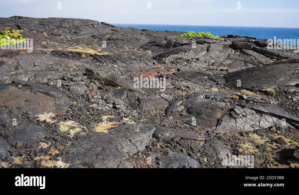 Walking over lava flows on the coast of Hawaii with the Pacific Ocean ...