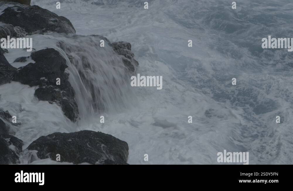 Waves and rocks party. Breaks and crush water over the ocean ...