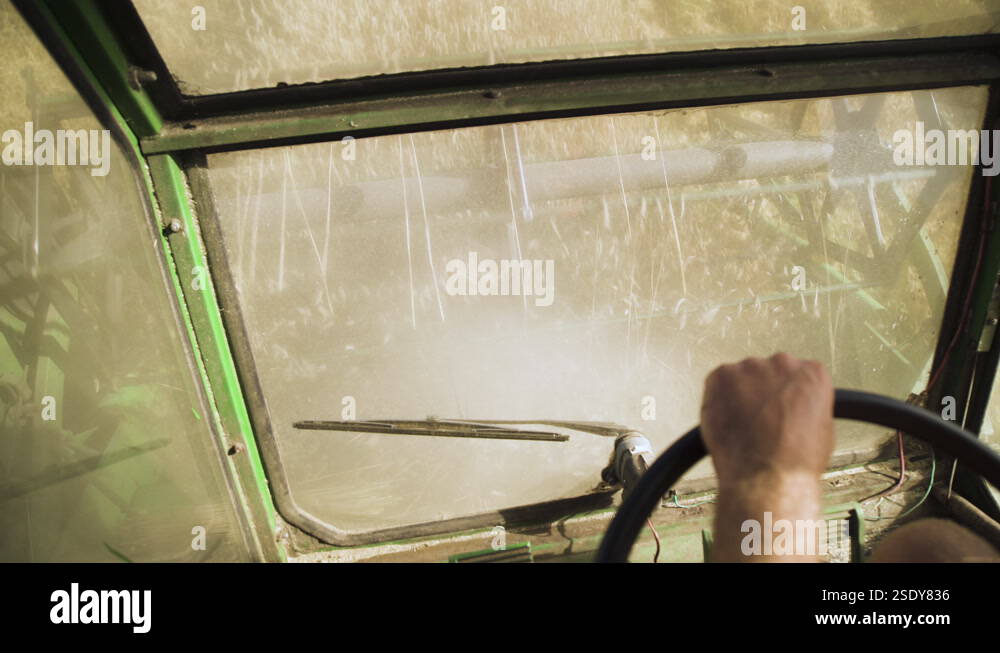 View inside combine harvester cabin, farmer driving agricultural ...