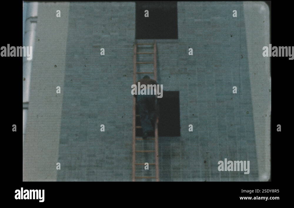 1960s: Shots of man climbing down ladder. Men outside building Stock ...